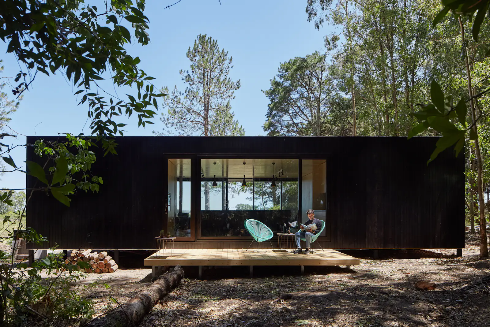 Photo 1 of 9 in This Black Prefab Cabin in Uruguay “Melts” Into the ...