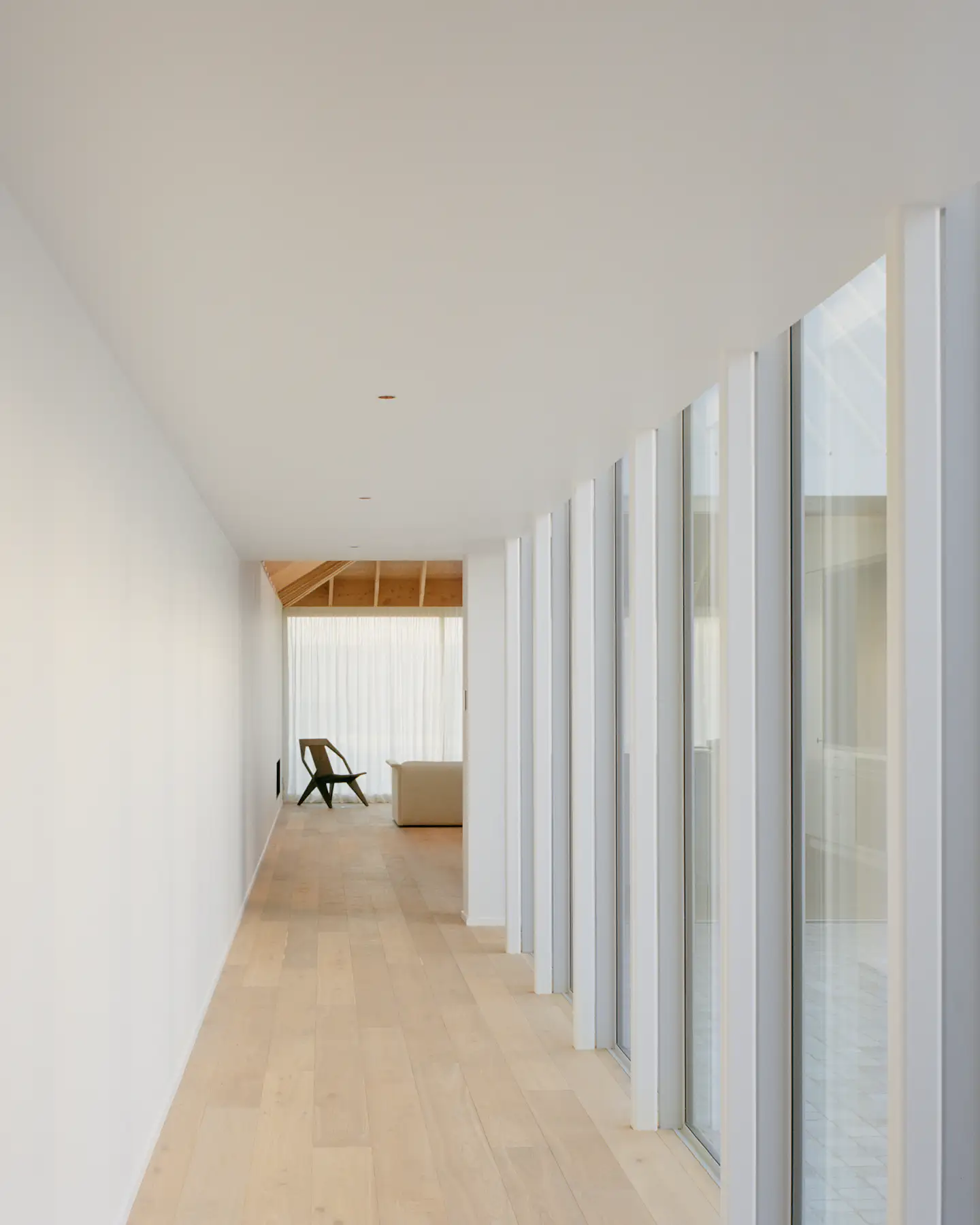 Photo 10 of 15 in Warm Wood Finishes Sandwich the White Interiors of a ...