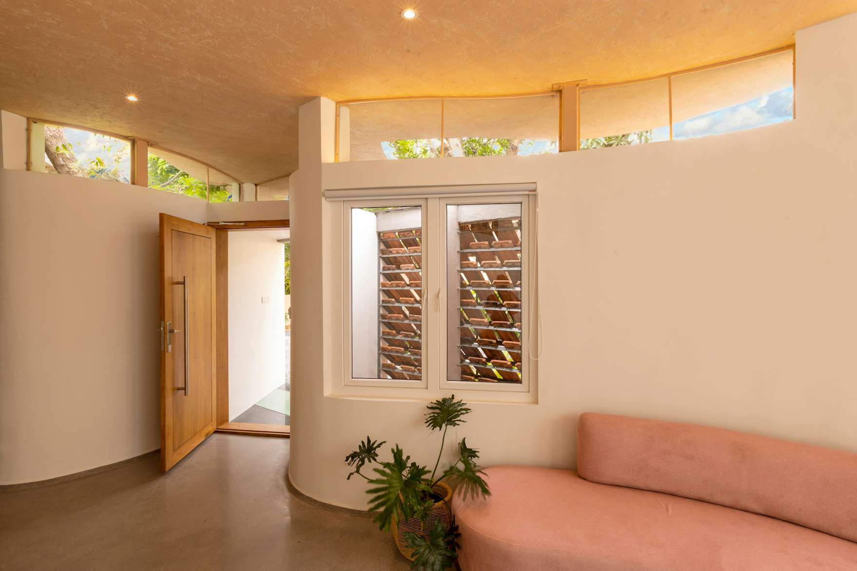 Photo 5 of 15 in Recycled Roof Shingles Become a Textured Fence For a Curved Home in India - Dwell