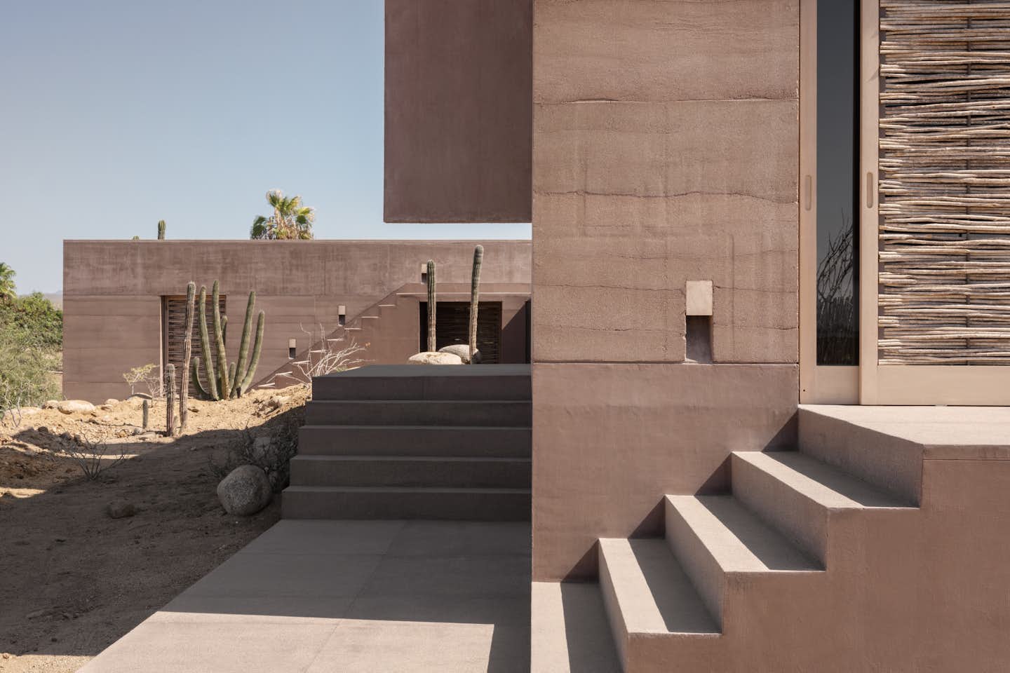 Photo 3 of 15 in A Dusty-Pink Rammed Earth Home Appears to Rise Out of ...