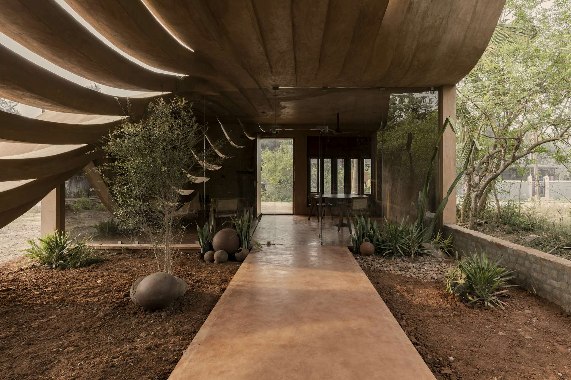 Photo 1 of 12 in A Wave of Concrete Ribbons Forms a Courtyard at This ...